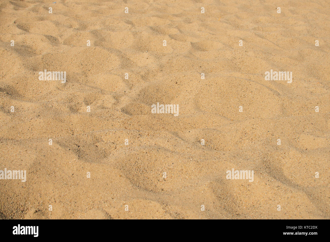 Close up on sand background or texture Stock Photo - Alamy