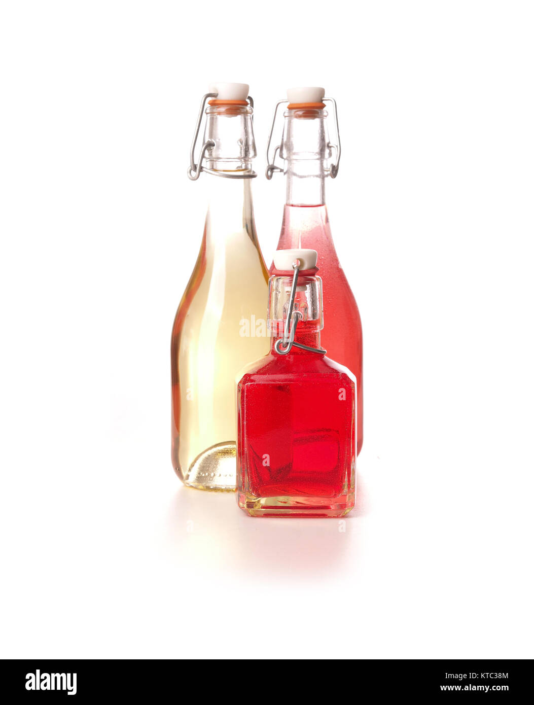 Three bottles of juice on a white background Stock Photo - Alamy
