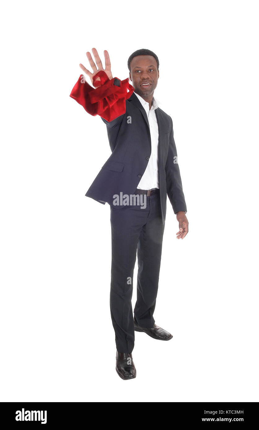 A tall handsome African American man standing in a dark suit and ...