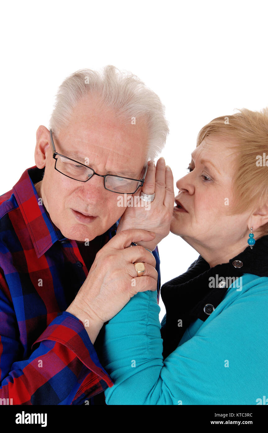 Wife whisper in husband ear Stock Photo - Alamy