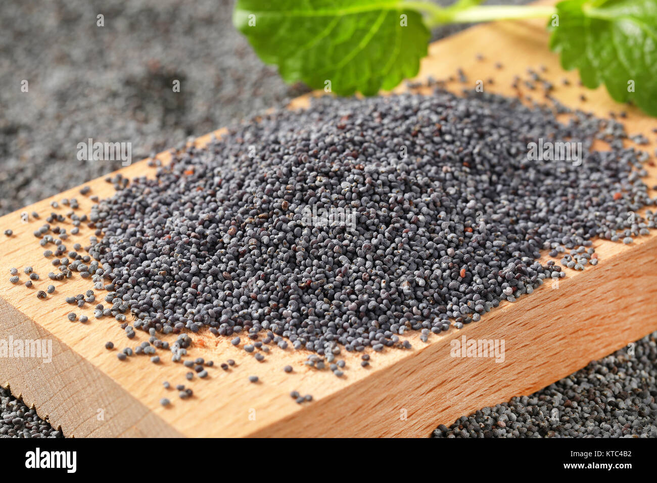 Whole black poppy seeds Stock Photo - Alamy