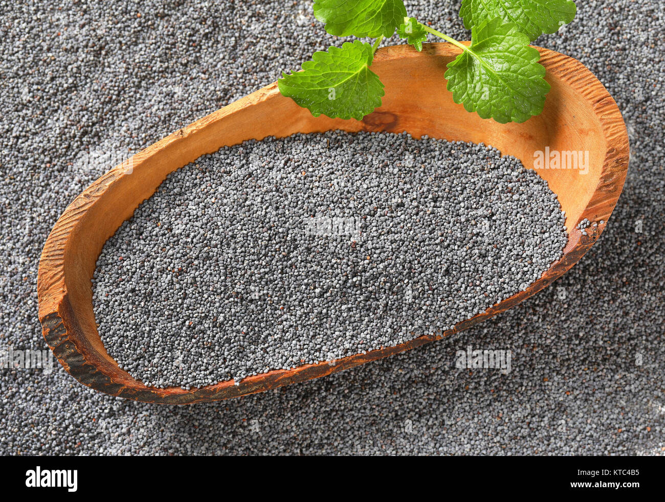 Whole black poppy seeds Stock Photo - Alamy