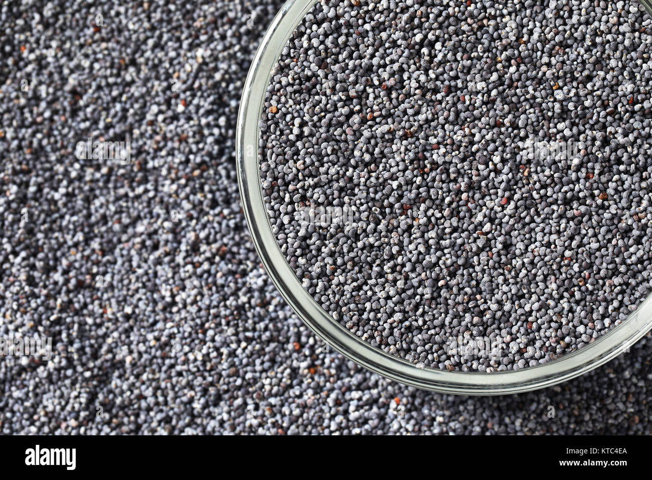 Whole black poppy seeds Stock Photo - Alamy