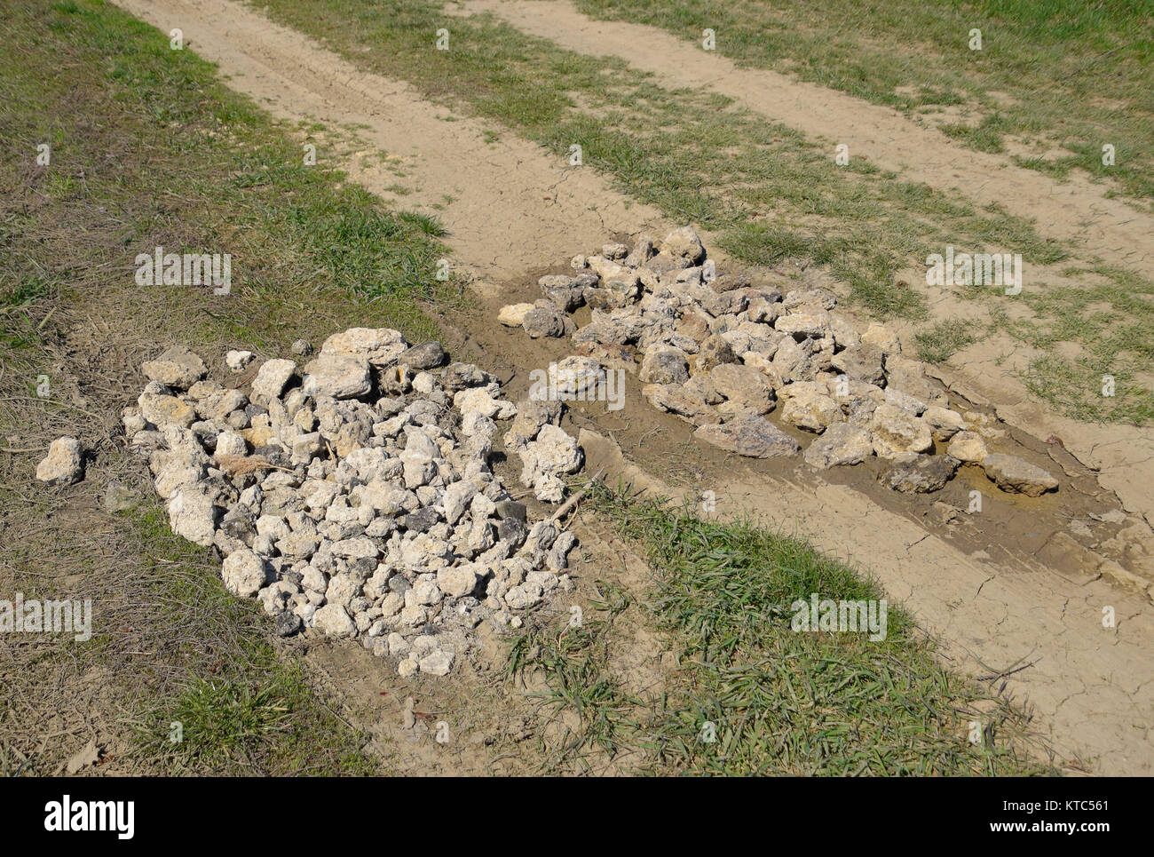 Road patching. Pits on the road are covered with stones Stock Photo - Alamy