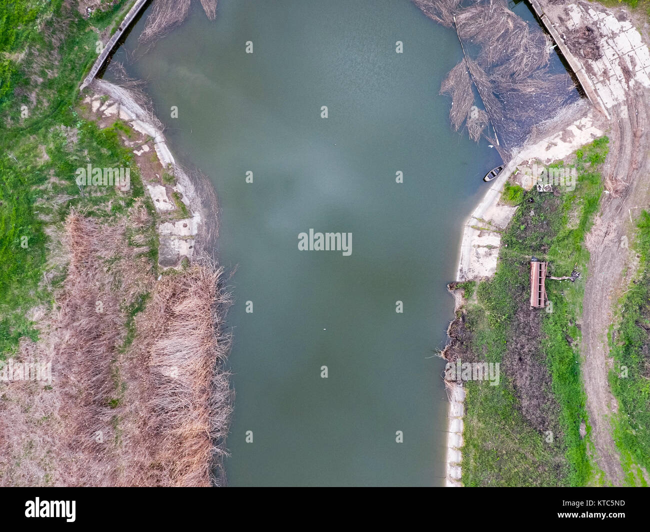 Paved concrete banks of the irrigation canal at the outlet of th Stock ...