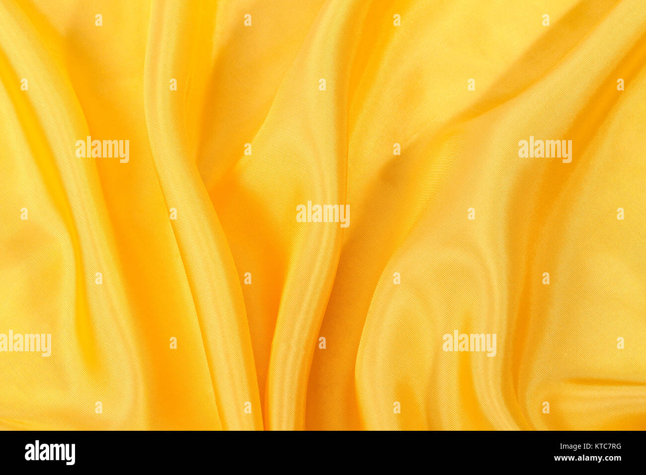 Silk background, texture of yellow shiny fabric Stock Photo - Alamy