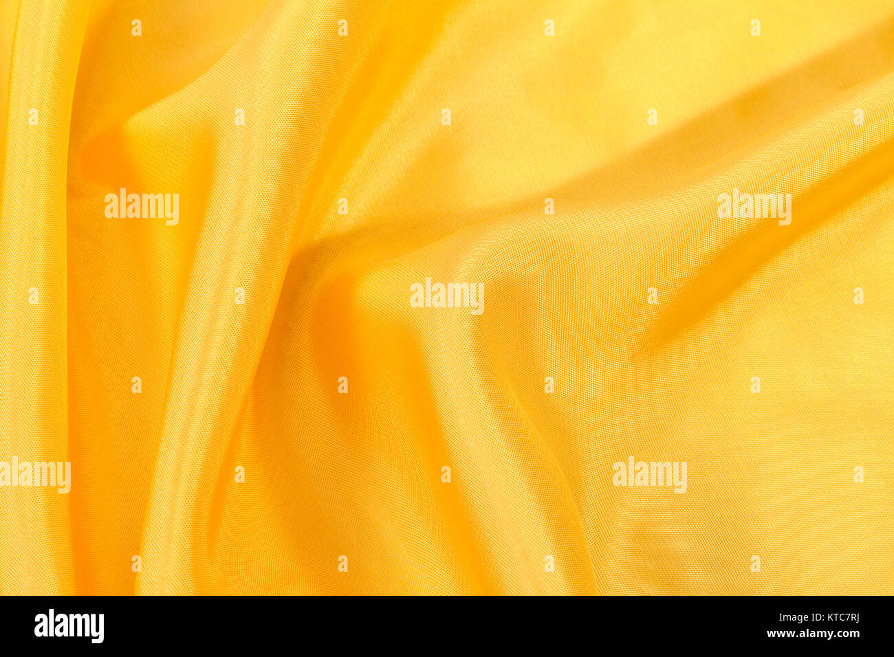 Silk background, texture of yellow shiny fabric Stock Photo - Alamy