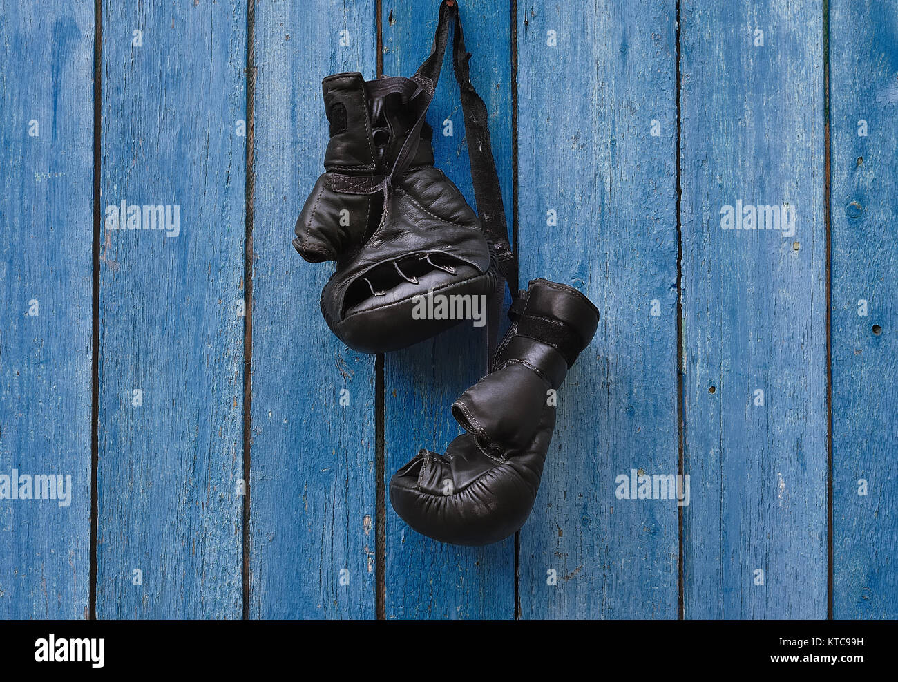 Black vintage boxing gloves hanging on an old rusty nail Stock Photo ...