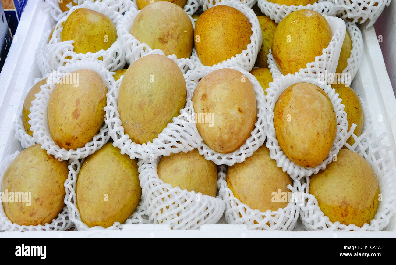 Sapota fresh fruits for sale at the street market in Asia. Close up ...