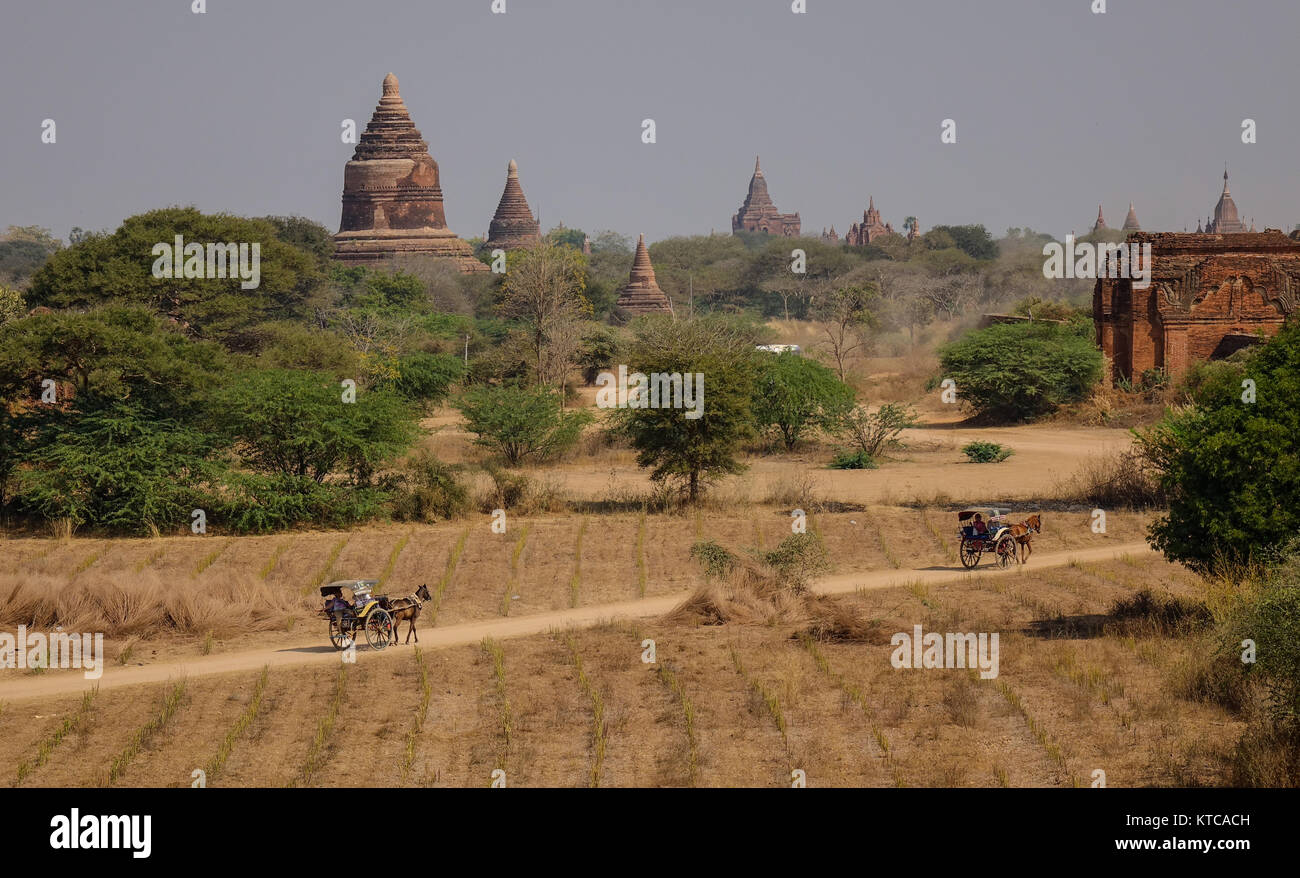 Horse carts with Buddhist temples in Bagan, Myanmar. Bagan is one of ...