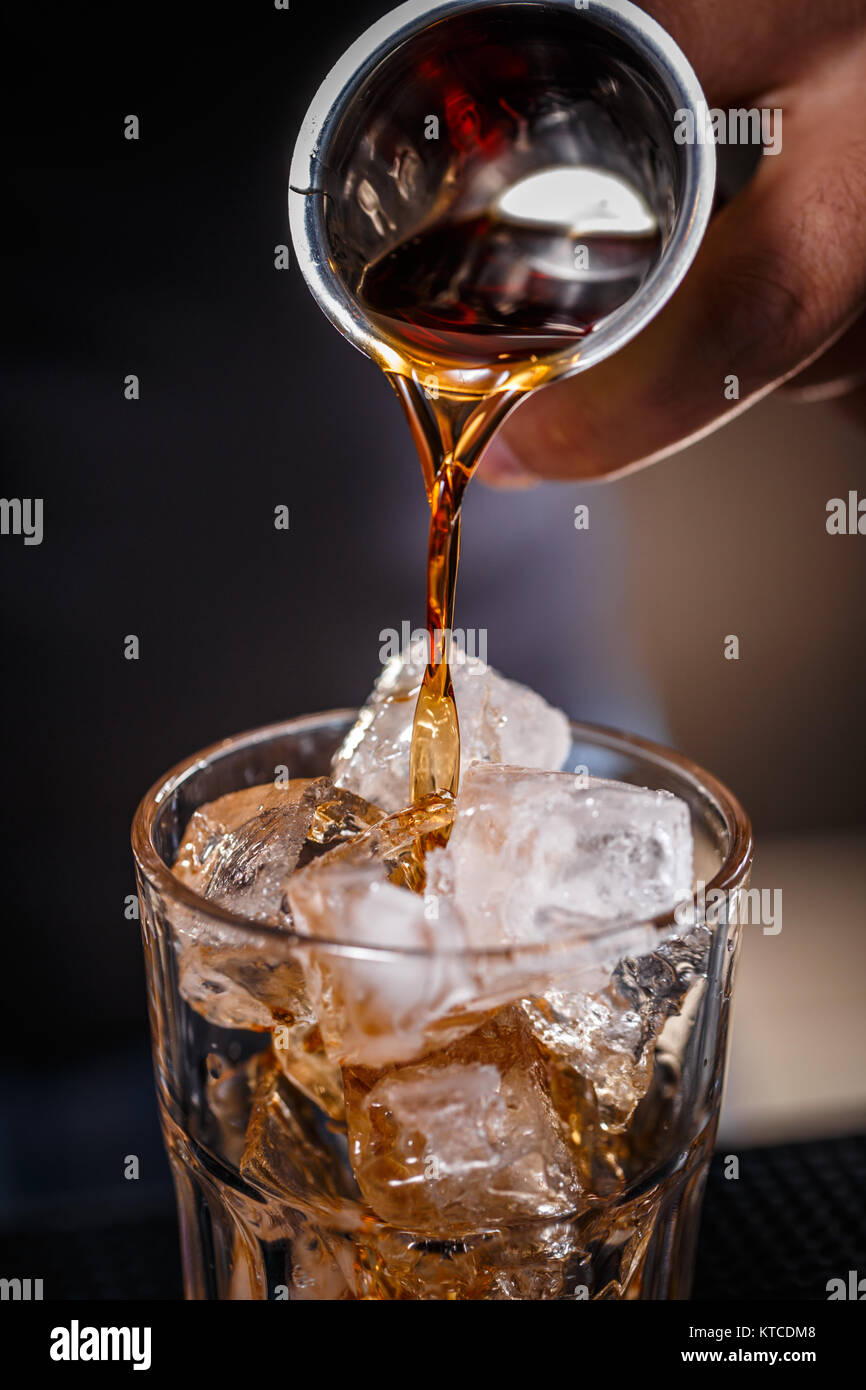 Bartender pouring alcohol Stock Photo - Alamy