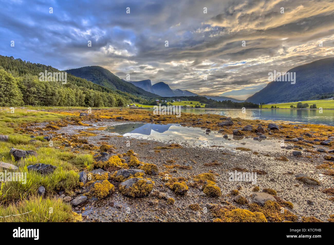 Fjord landscape with mountains rocks and stones at low tide on ...