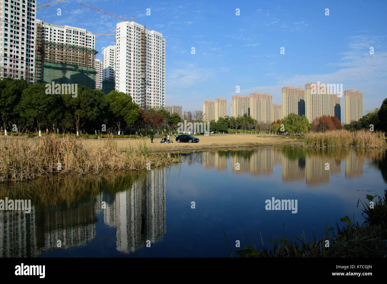 View over lake with apartment building reflections on water with open ...