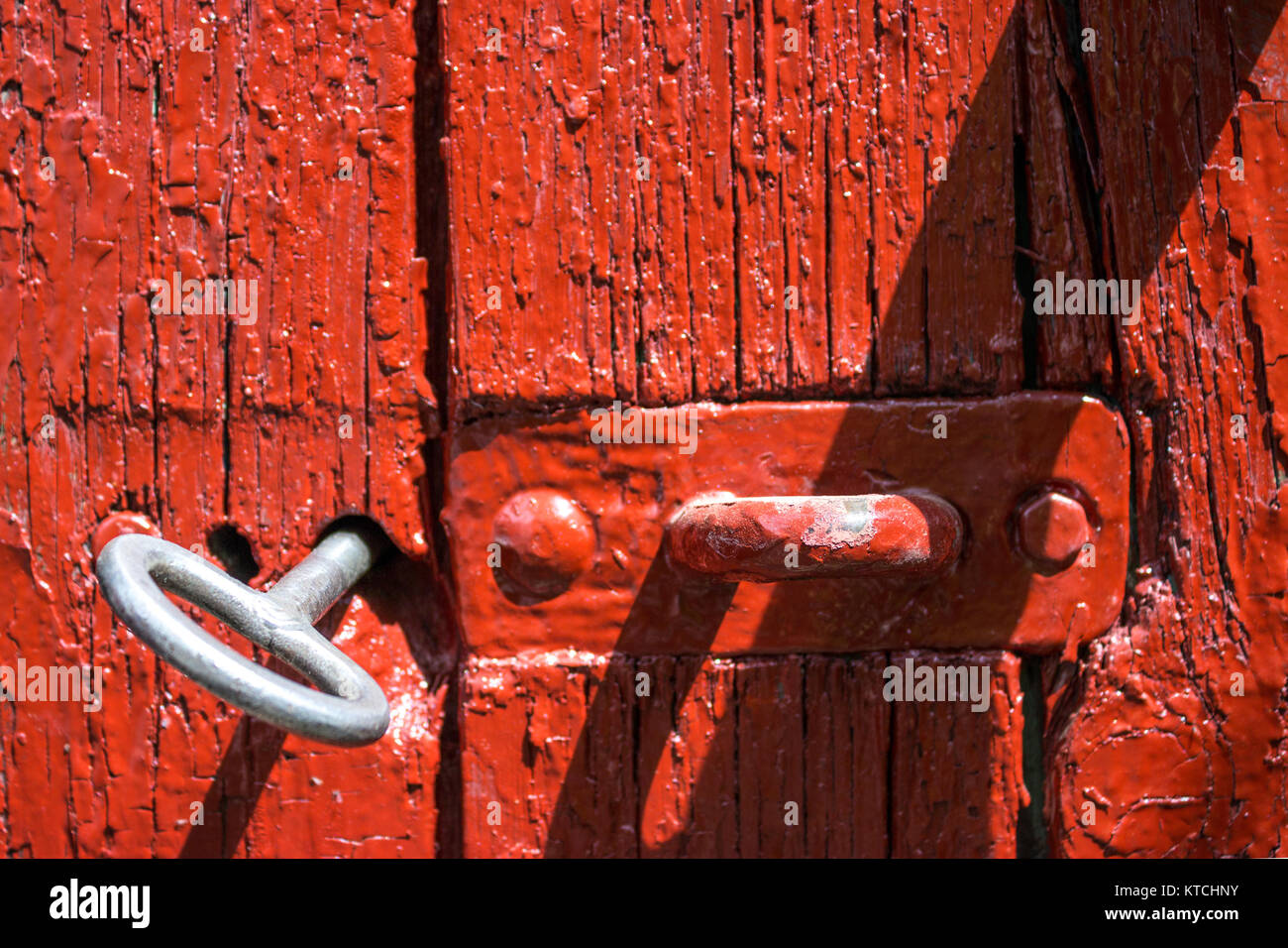 Antique iron key from the gate in the old red wooden gate Stock Photo ...