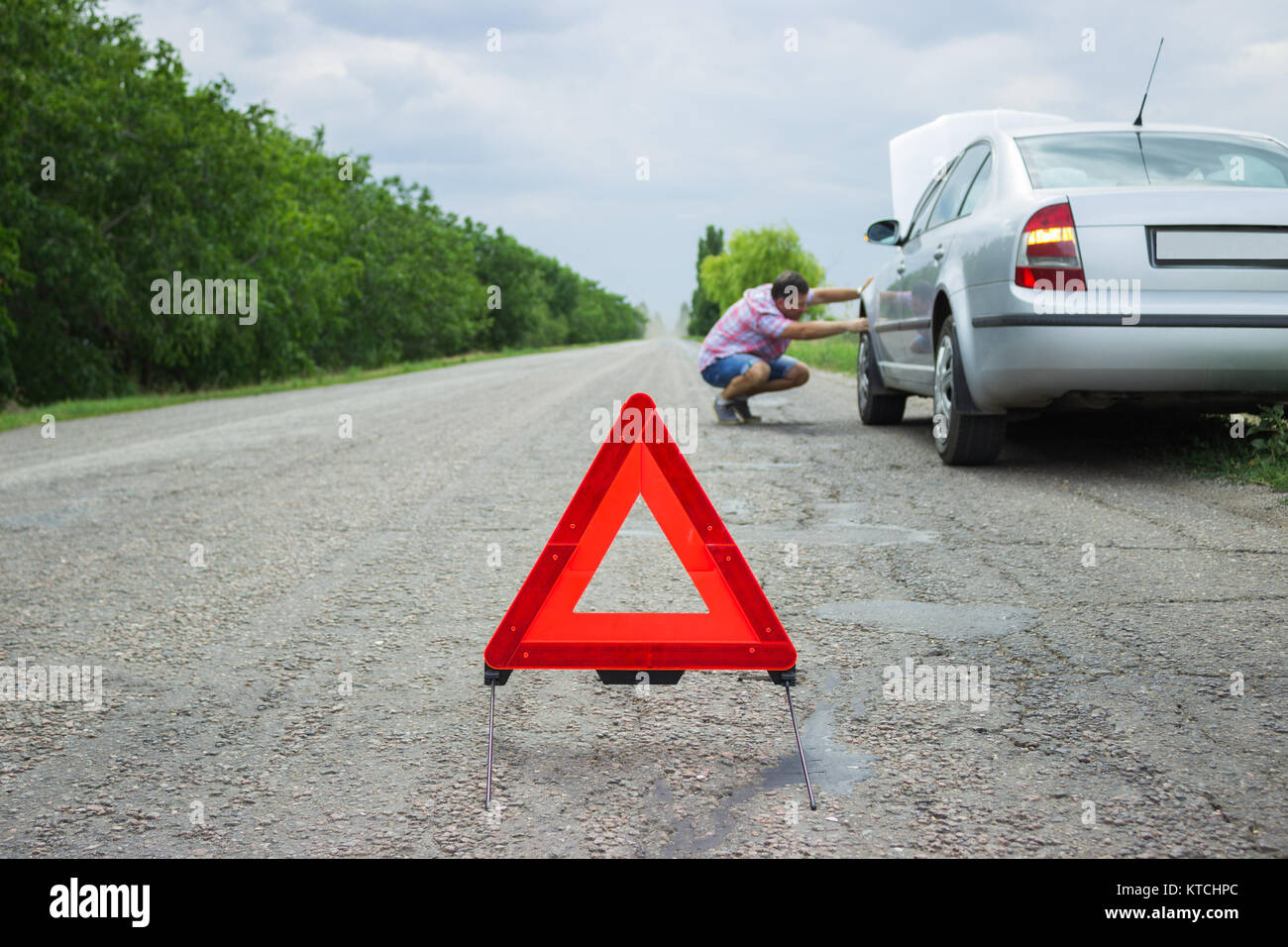 Red warning triangle with a broken down car. Breakdown of the car in ...