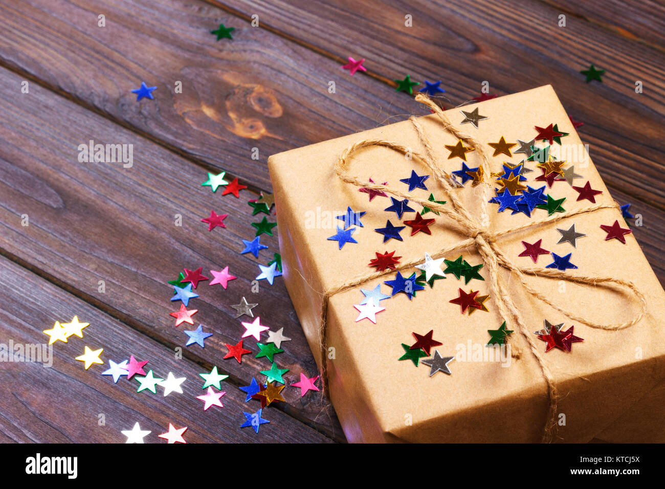 Gift box with star. Creative concept with festive decor on black ...