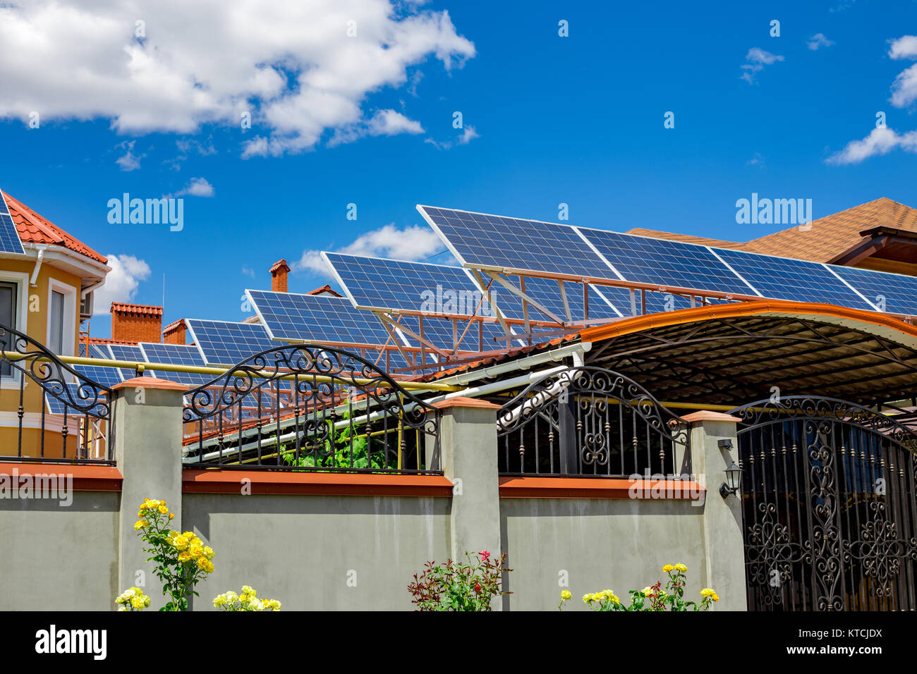 Roof with solar panel reflecting the sun, in the background a perfectly ...