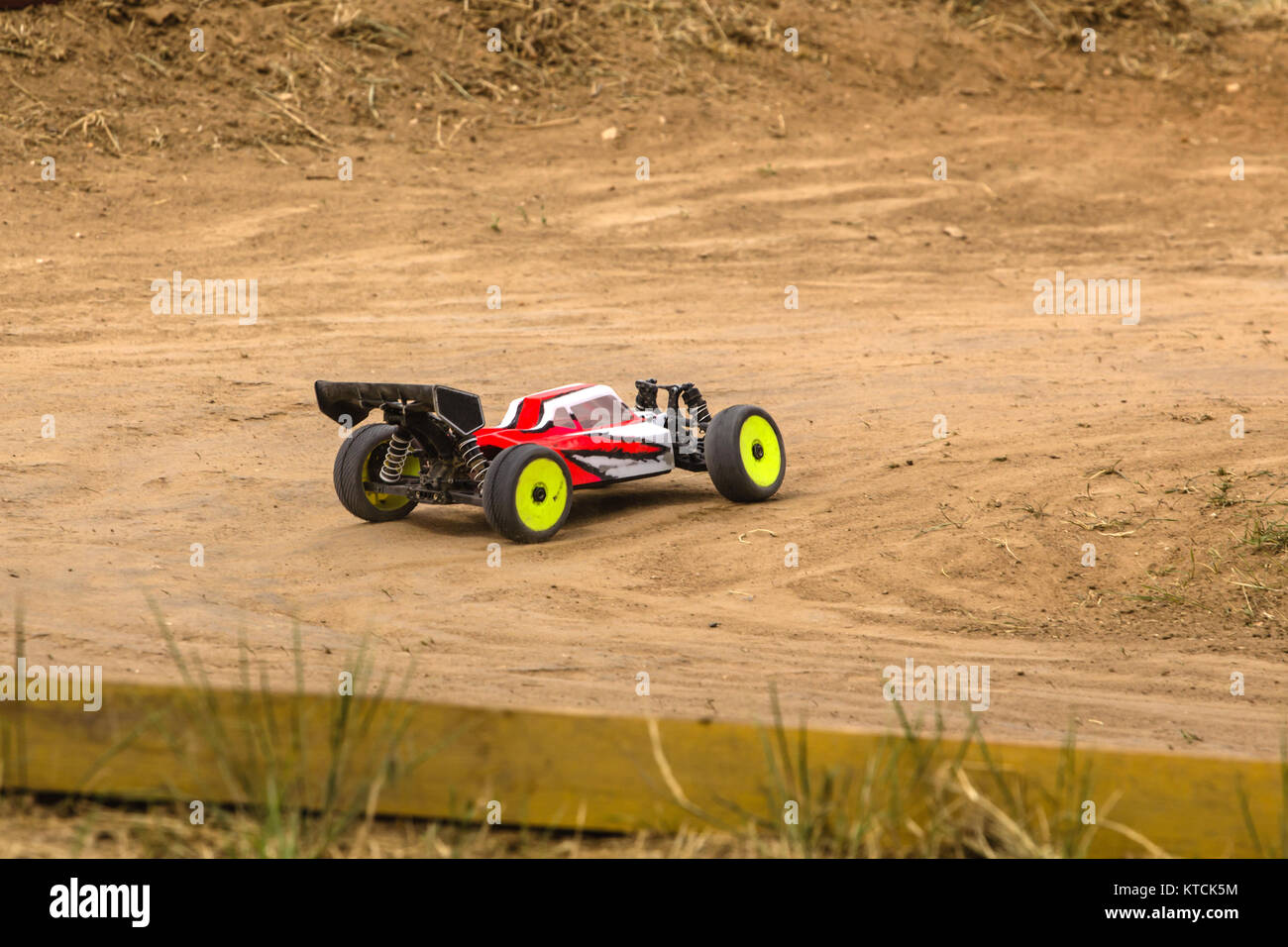 Radio controlled car model in race on dirt track Stock Photo - Alamy