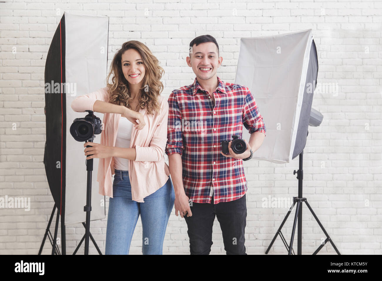 two young photographer in studio with lighting at the background Stock ...