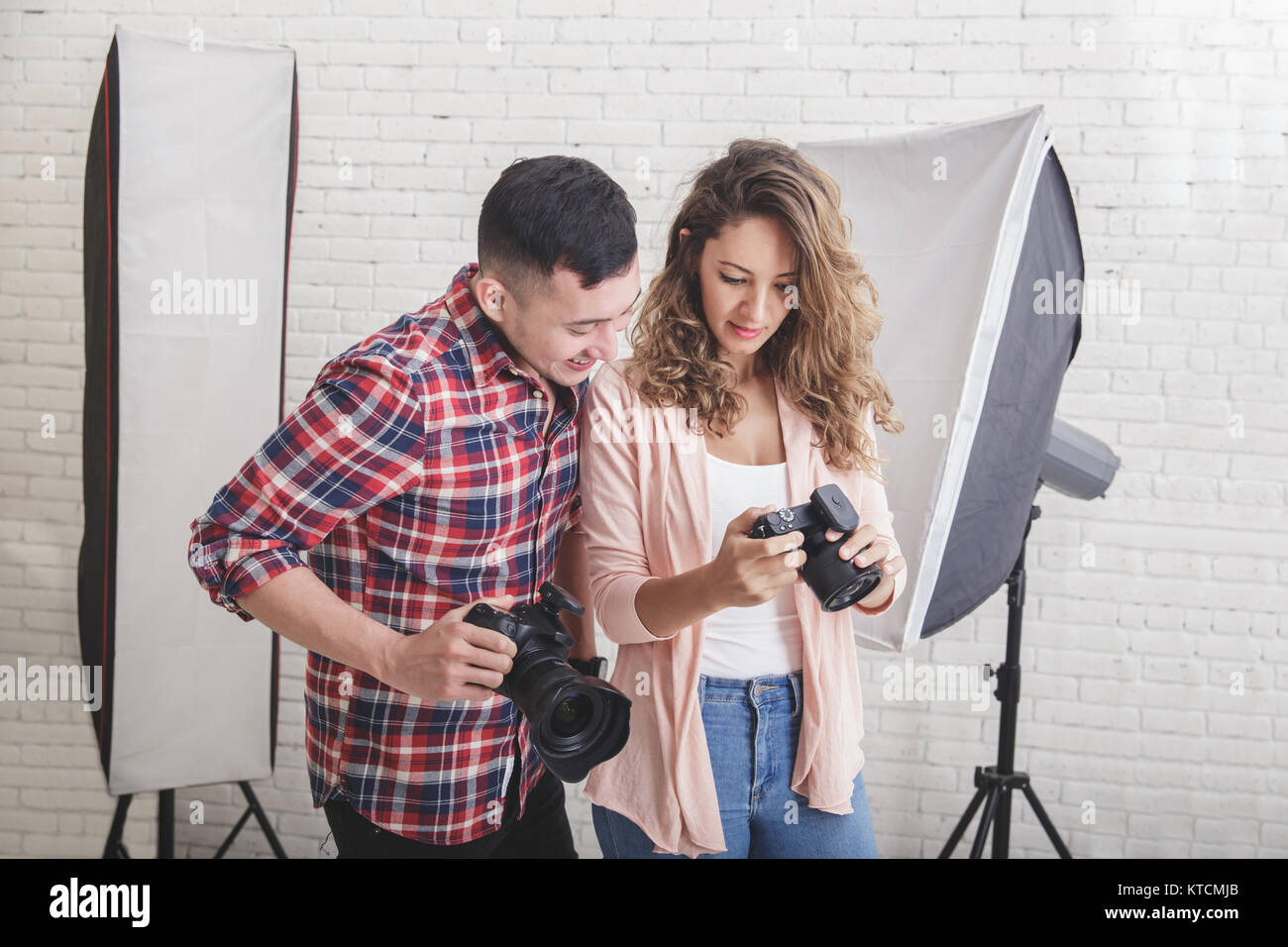 young photographer view photo preview in her camera share with h Stock ...