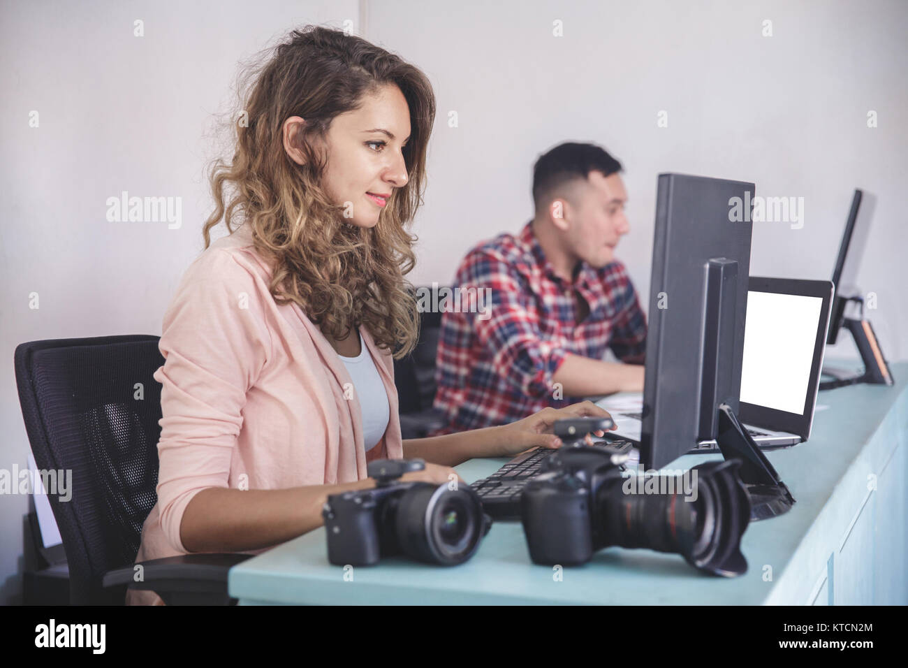 two photographers editing photos in their computer after photo s Stock ...