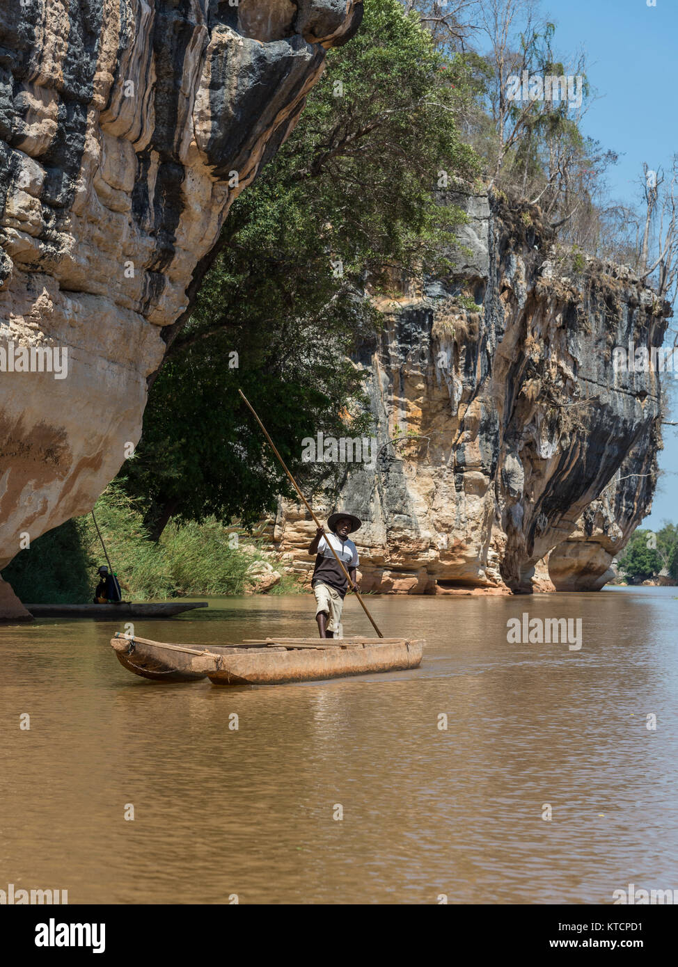 A Malagasy man on a dugout canoe at the Manambolo River running through ...