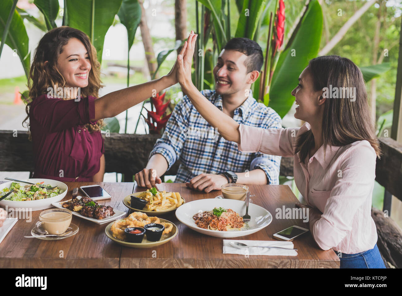 beautiful woman high five with her bestfriends during lunch toge Stock ...