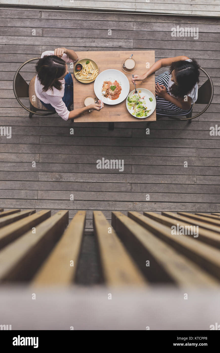 two young woman having lunch together Stock Photo - Alamy