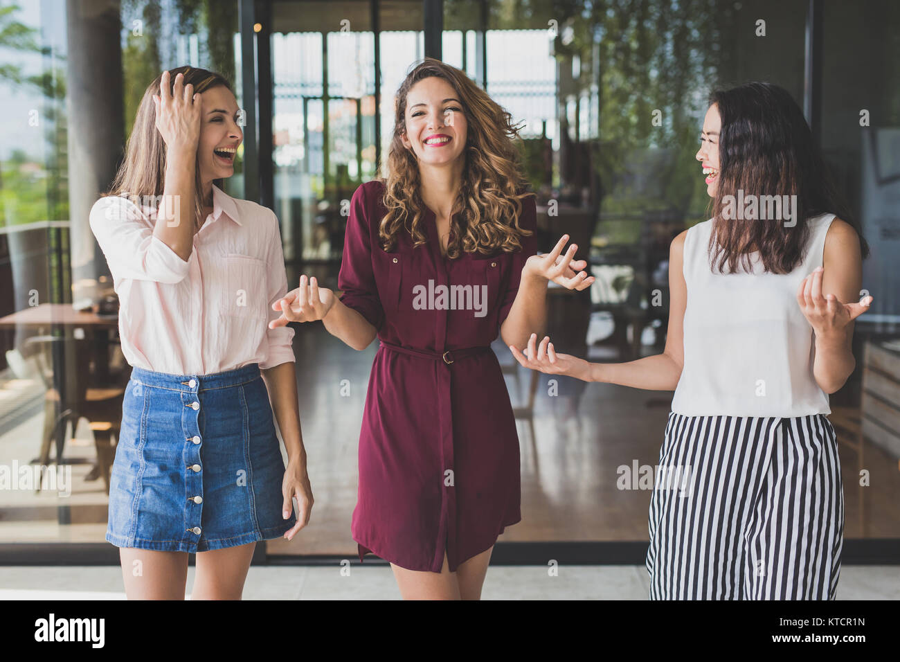 group of three best friend having conversation while walking tog Stock ...