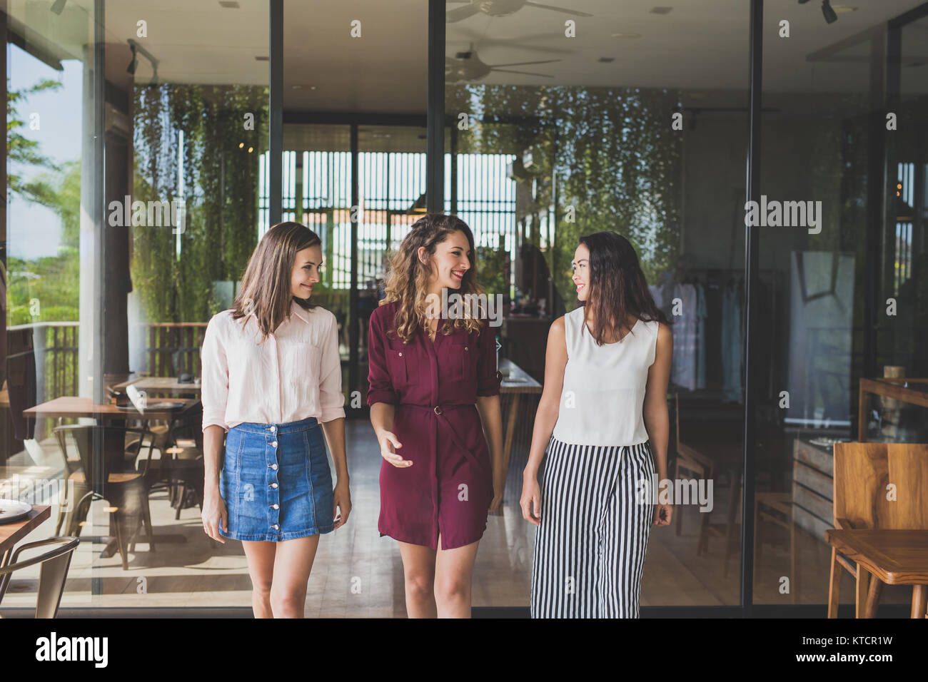 group of three best friend having conversation while walking tog Stock ...