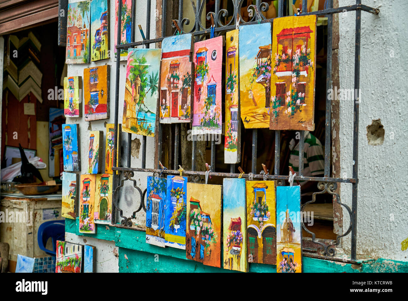 small shop with paintings on barred window at typical facades of ...
