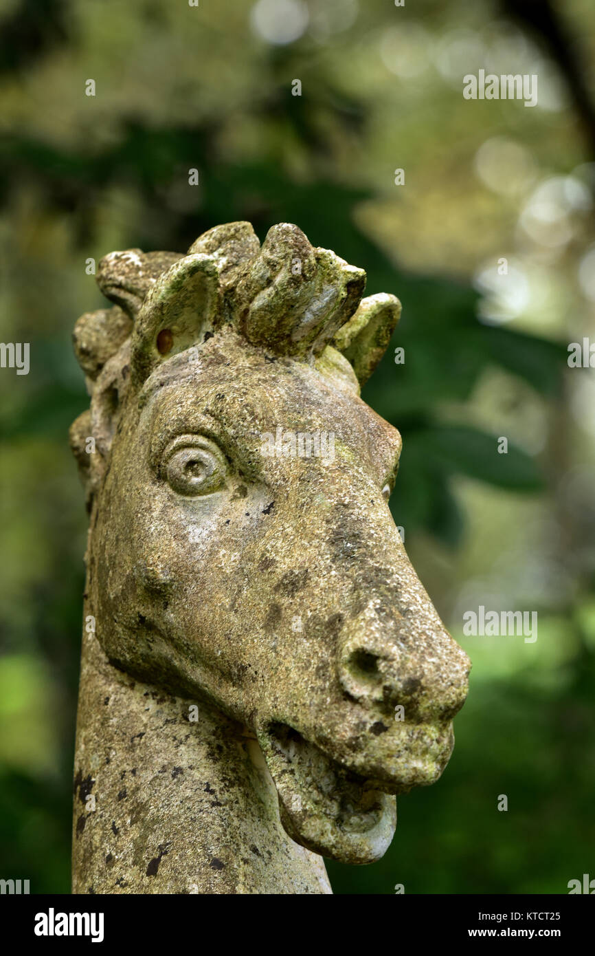 a piece of vintage or antique moss covered garden statuary in the form ...