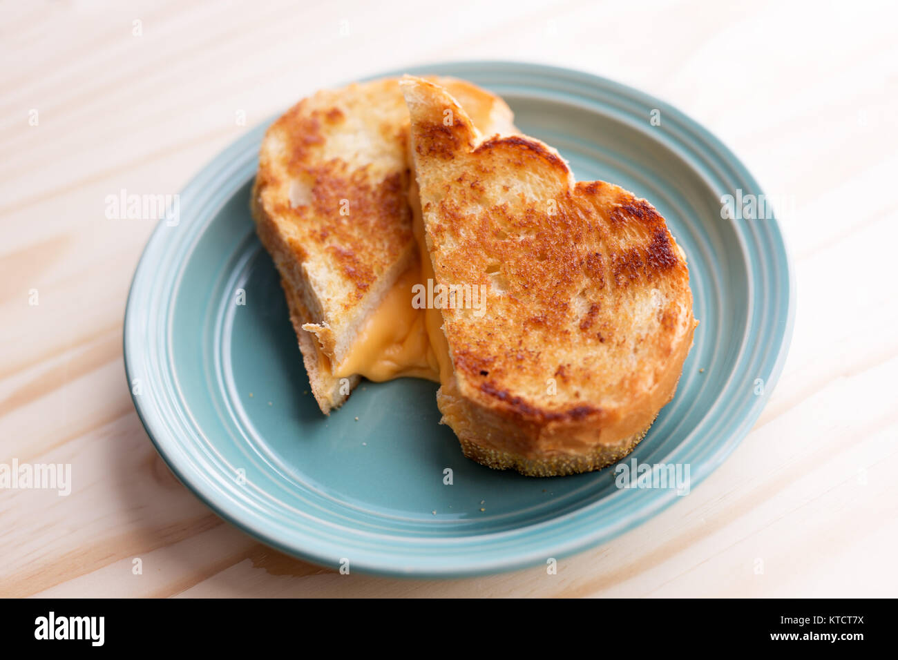 Grilled cheese sandwich on a blue plate Stock Photo - Alamy