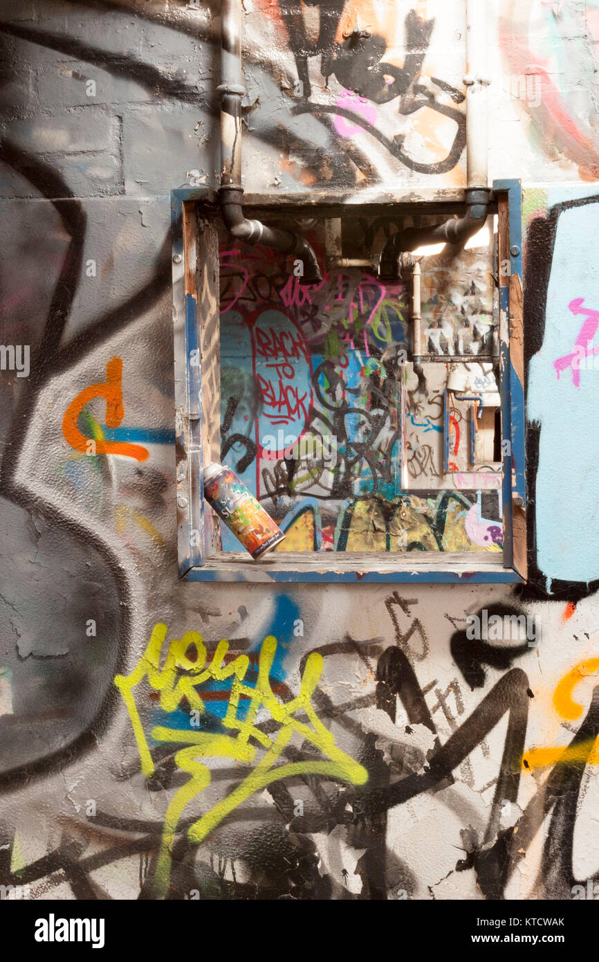 Spray paint tin on ledge with graffiti background Stock Photo - Alamy