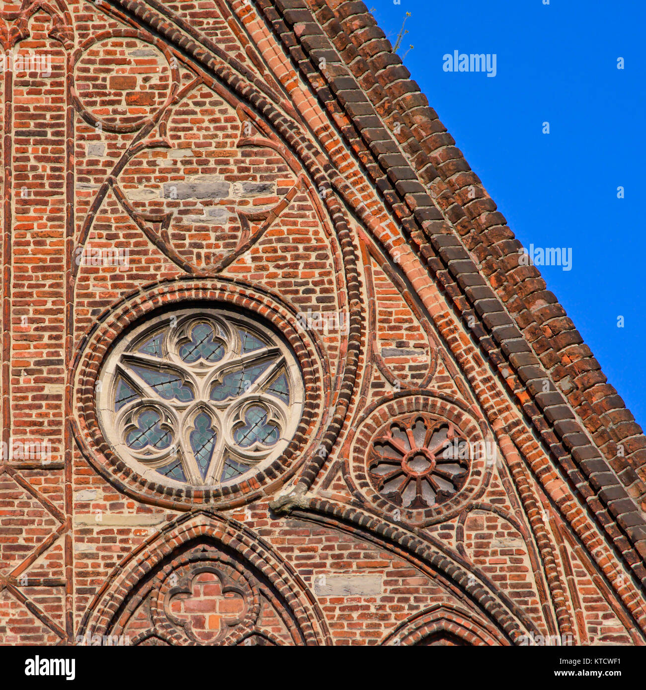 Rosette window and decorated brick wall, part of the Gothic church of ...