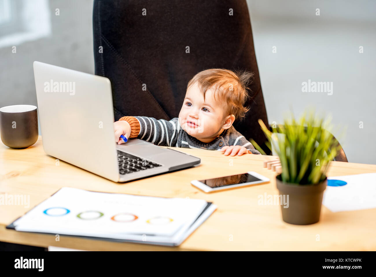Baby boss working with laptop sitting on the chair at the office Stock ...