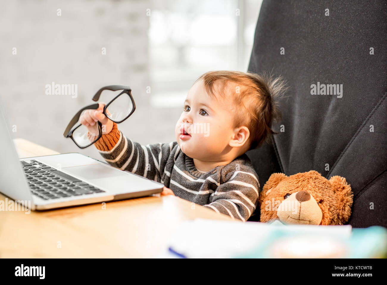 Baby boss working with laptop sitting on the chair at the office Stock ...