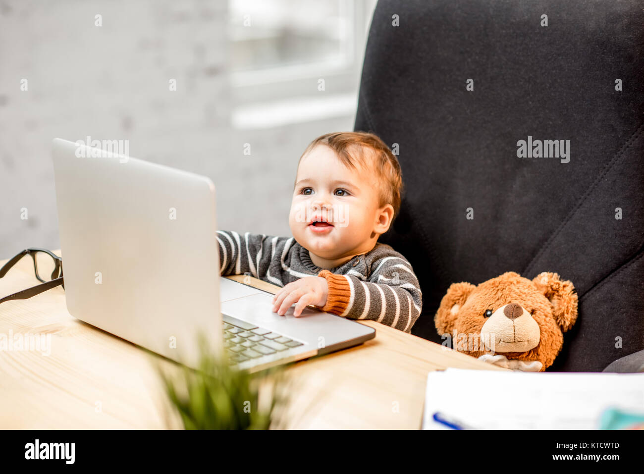 Baby boss working with laptop sitting on the chair at the office Stock ...