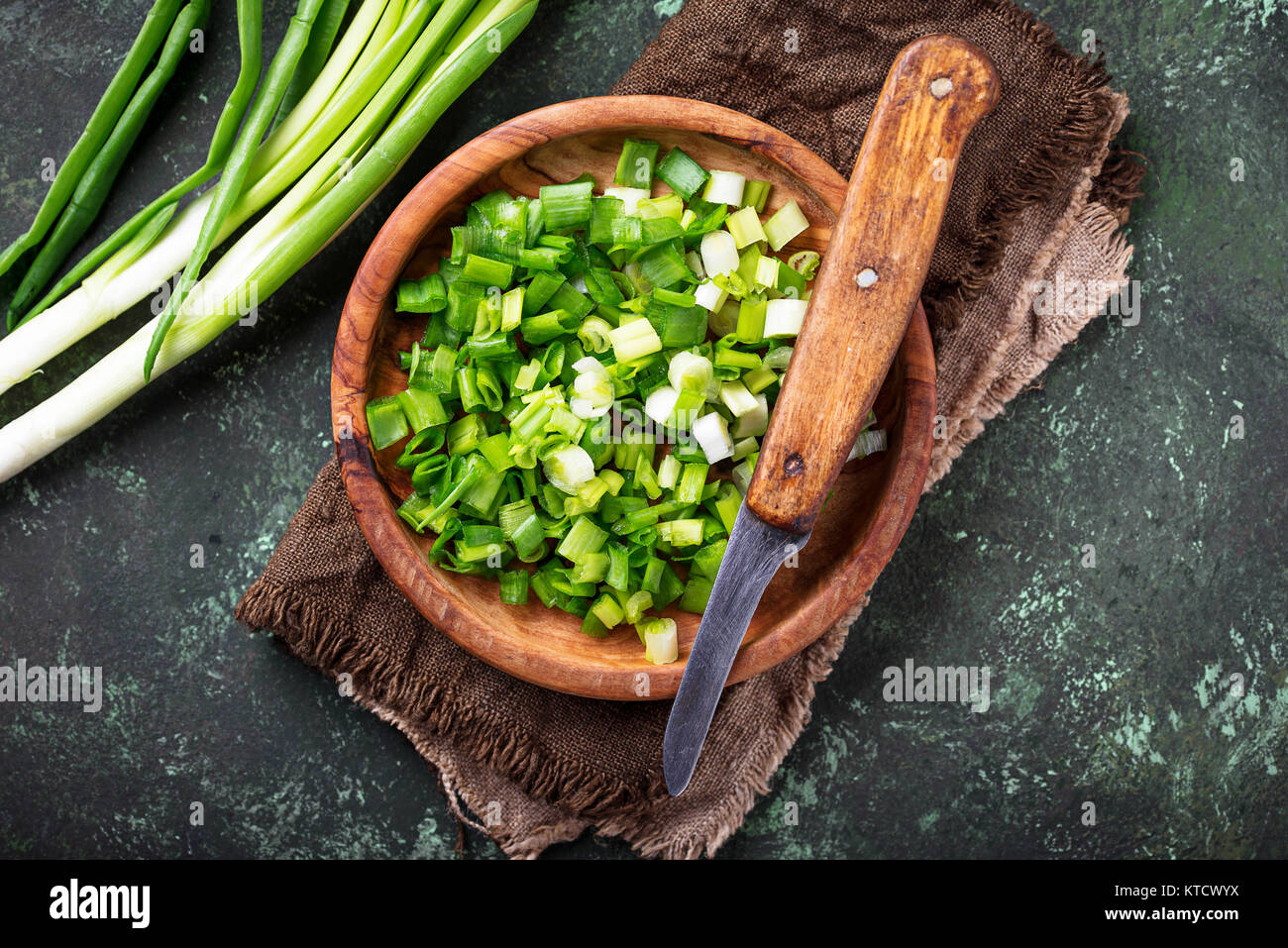 Chopped green onions on concrete background. Selective focus, top view ...
