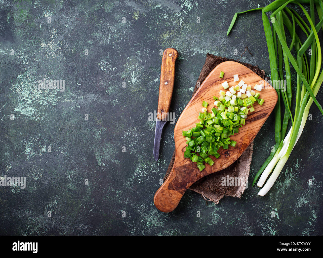 Chopped green onions on concrete background. Selective focus, top view ...