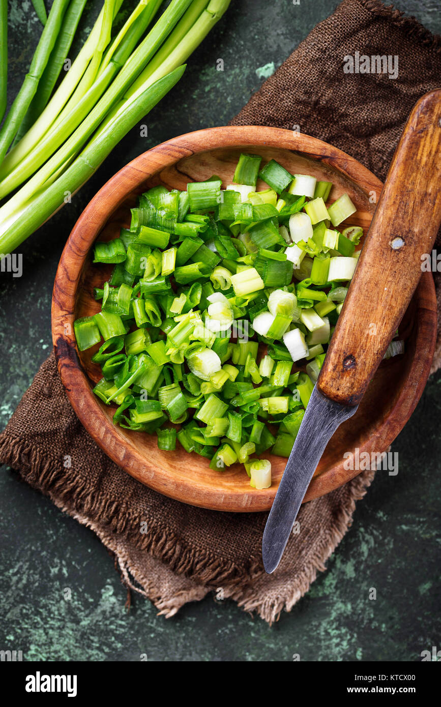 Chopped green onions on concrete background. Selective focus, top view ...