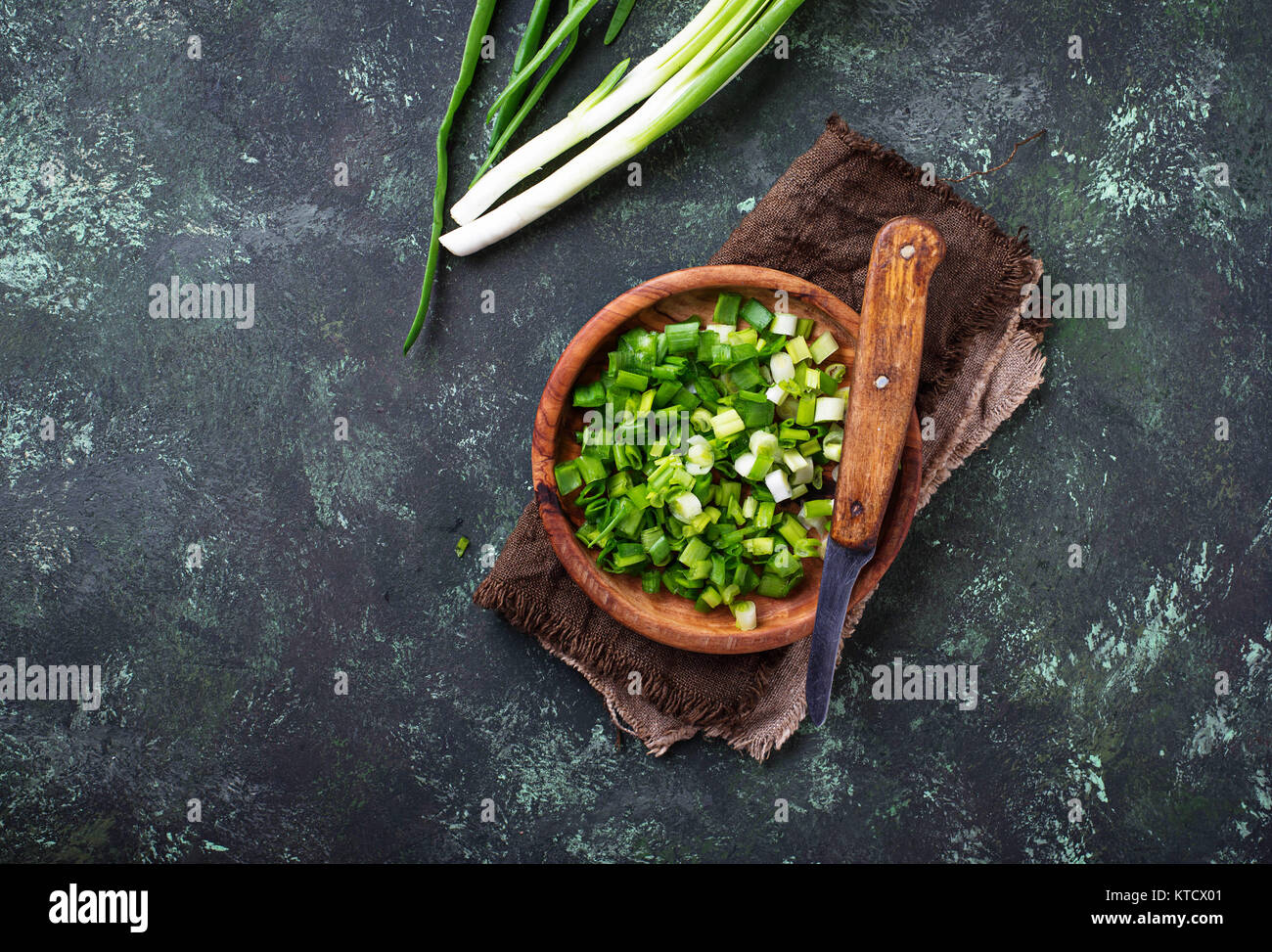 Chopped green onions on concrete background. Selective focus, top view ...