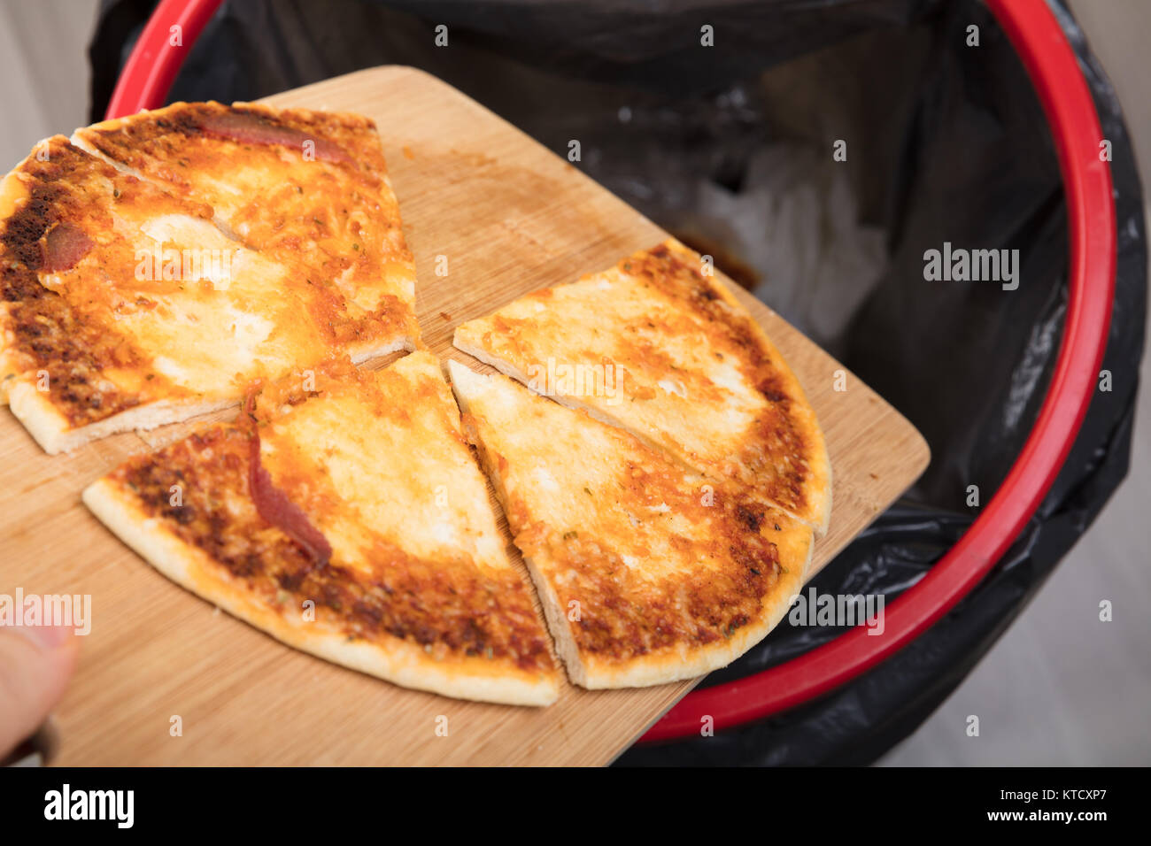 Person Throwing Pepperoni Pizza In Dustbin Stock Photo - Alamy