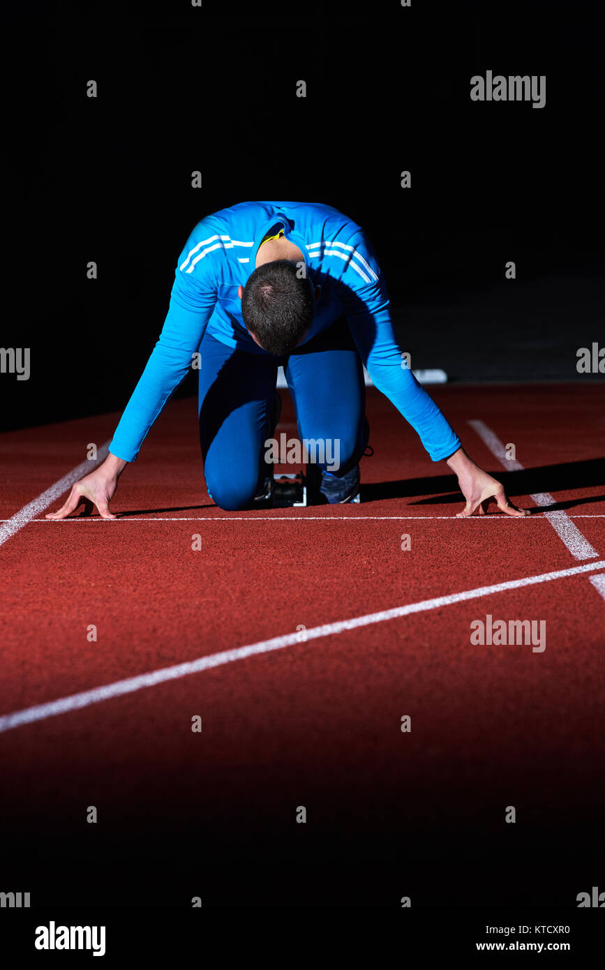 Sport. Sprinter leaving starting blocks on the running track Stock ...