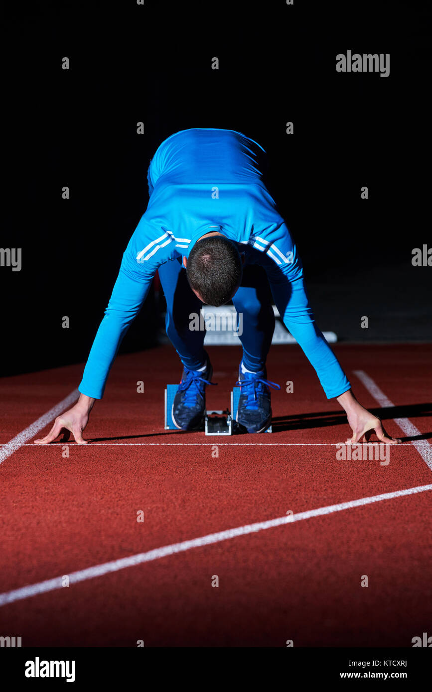 Sport. Sprinter leaving starting blocks on the running track Stock ...