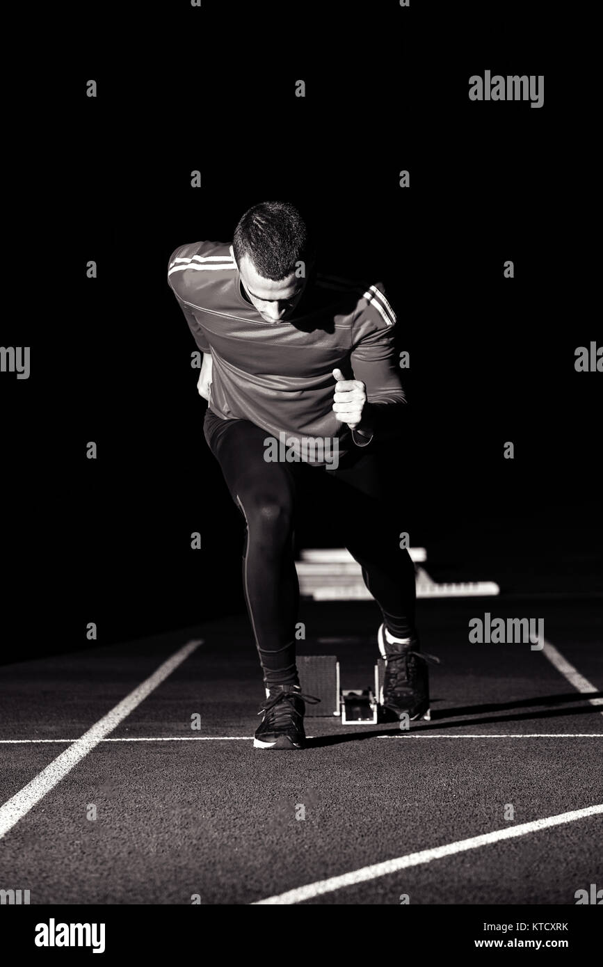 Sport. Sprinter leaving starting blocks on the running track Stock ...