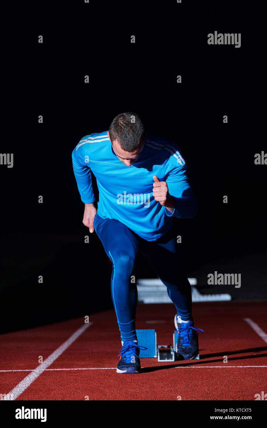 Sport. Sprinter leaving starting blocks on the running track Stock ...