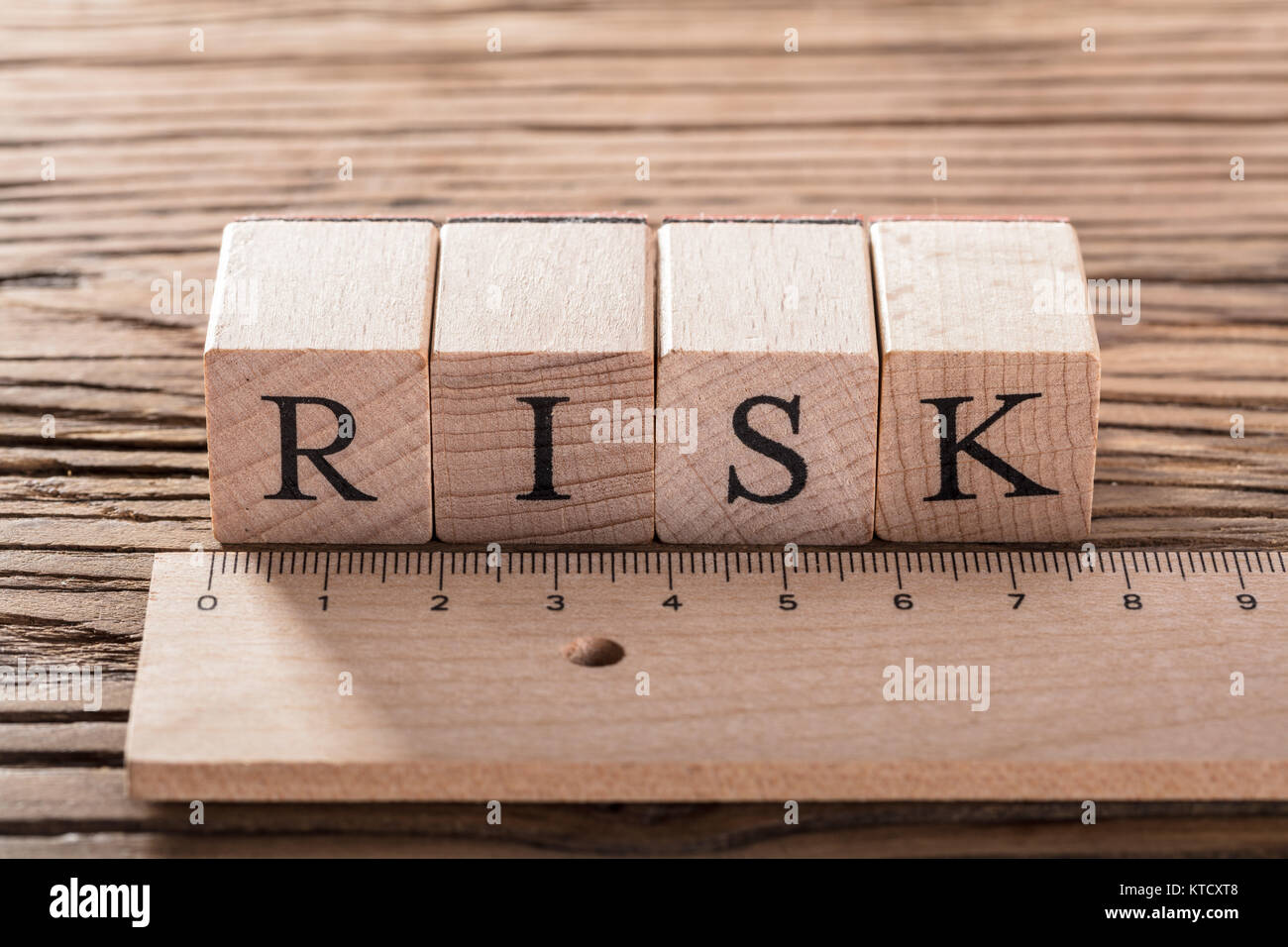 Risk Concept With Wooden Ruler Stock Photo - Alamy