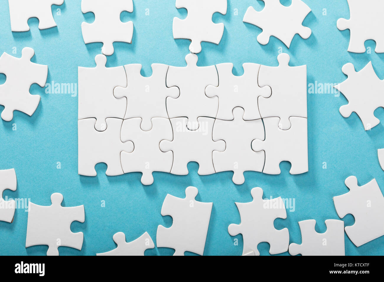 White Jigsaw Puzzles On Blue Background Stock Photo - Alamy