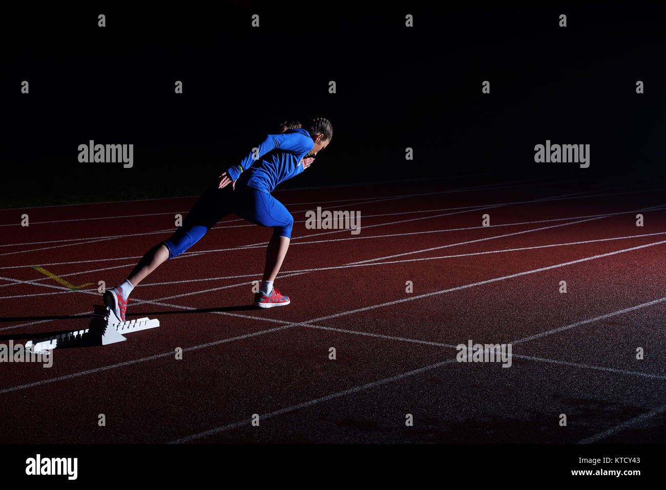 Young female athlete on starting blocks hi-res stock photography and ...
